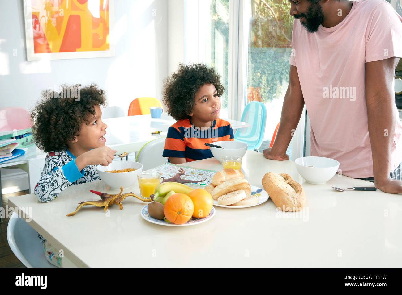 Family enjoying breakfast together Stock Photo - Alamy