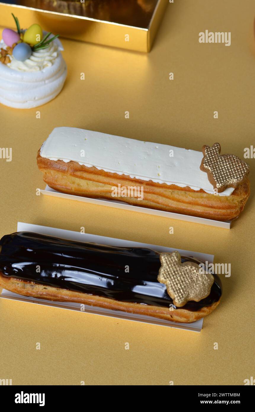 Delicious Eclairs on Golden Background, Chocolate and Vanilla Icing ...