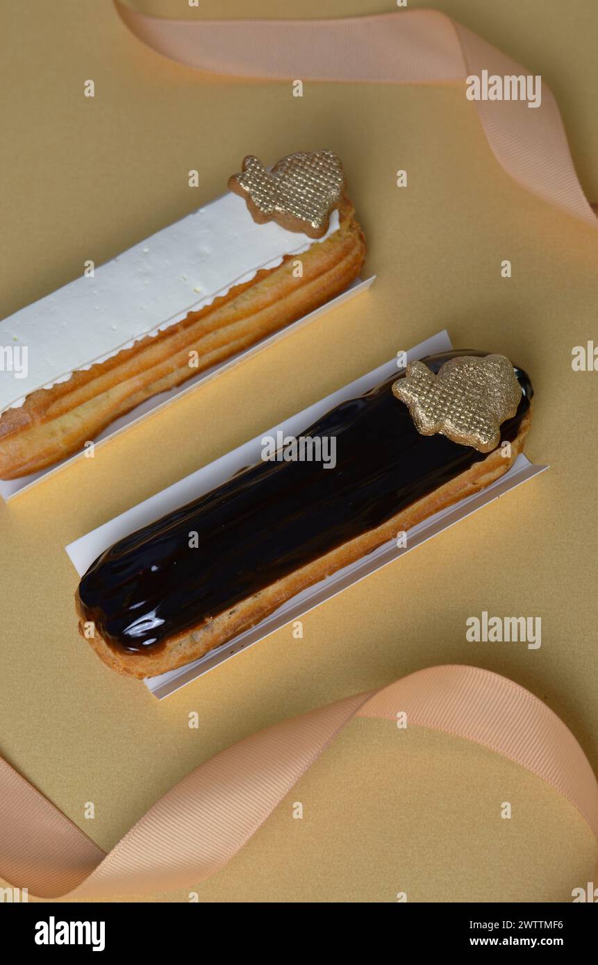 Delicious Eclairs on Golden Background, Chocolate and Vanilla Icing ...