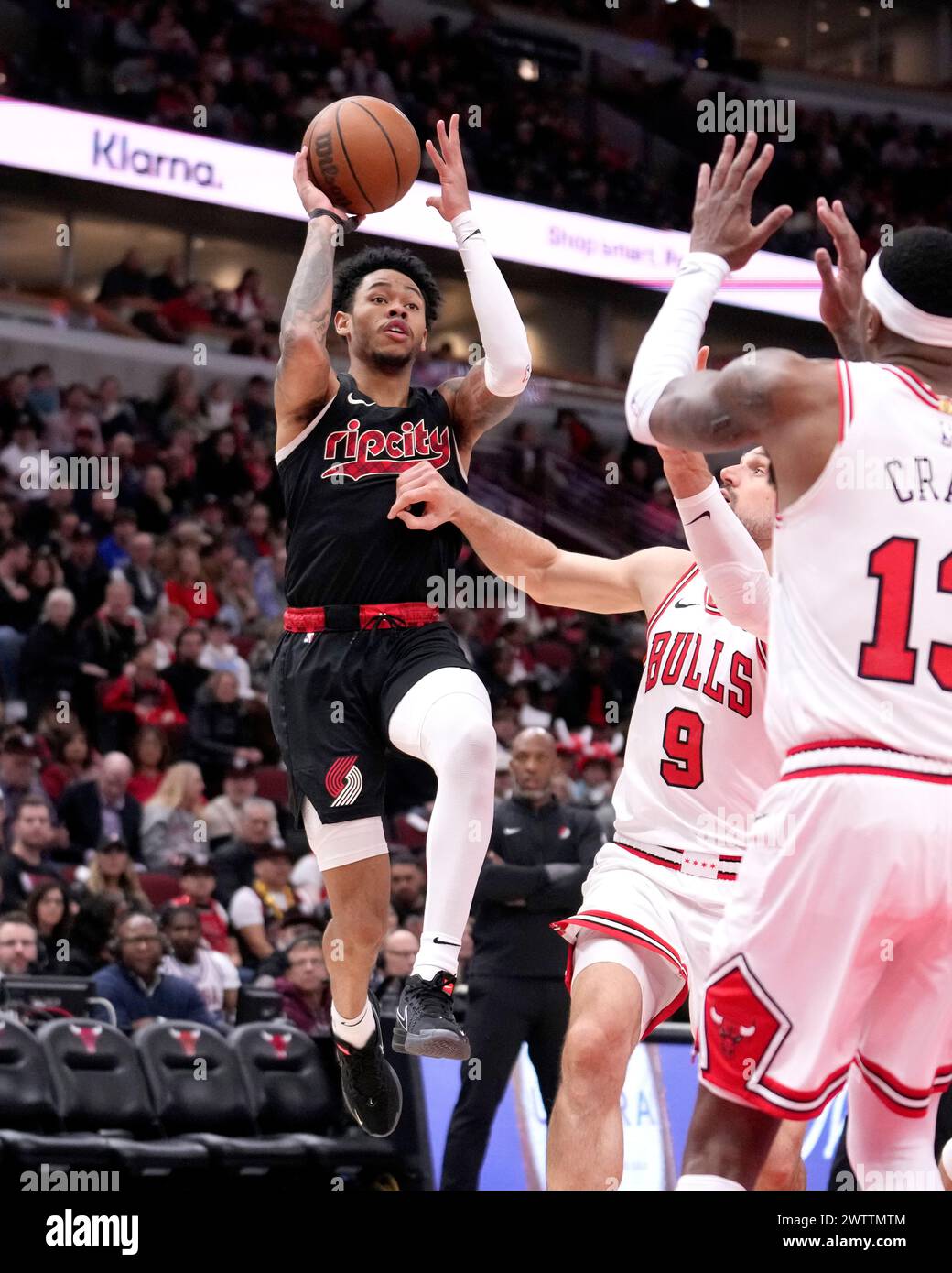 Portland Trail Blazers' Rayan Rupert shoots as Chicago Bulls' Nikola Vucevic (9) and Torrey ...