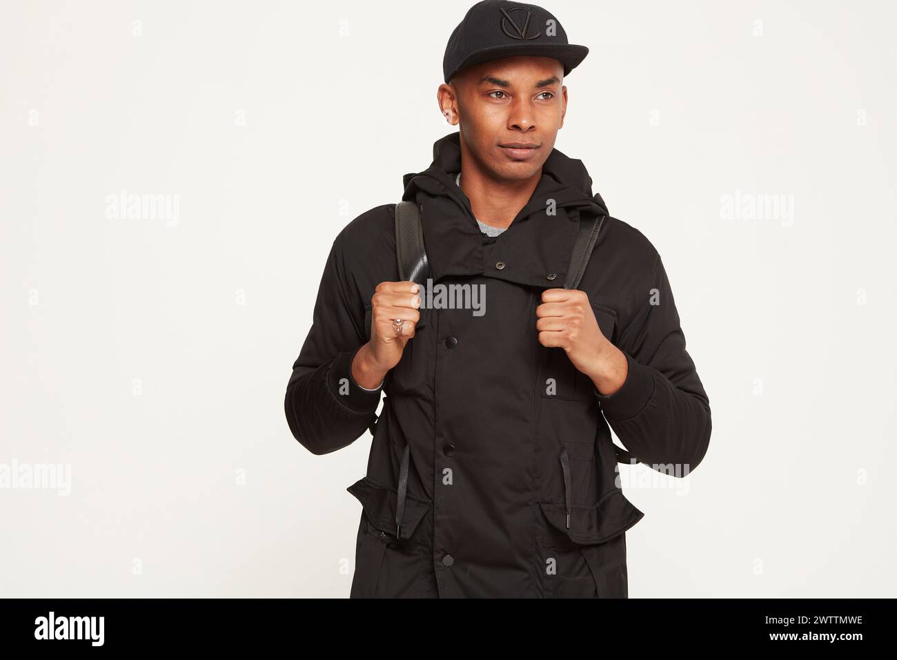Man in black cap and hoodie posing Stock Photo - Alamy