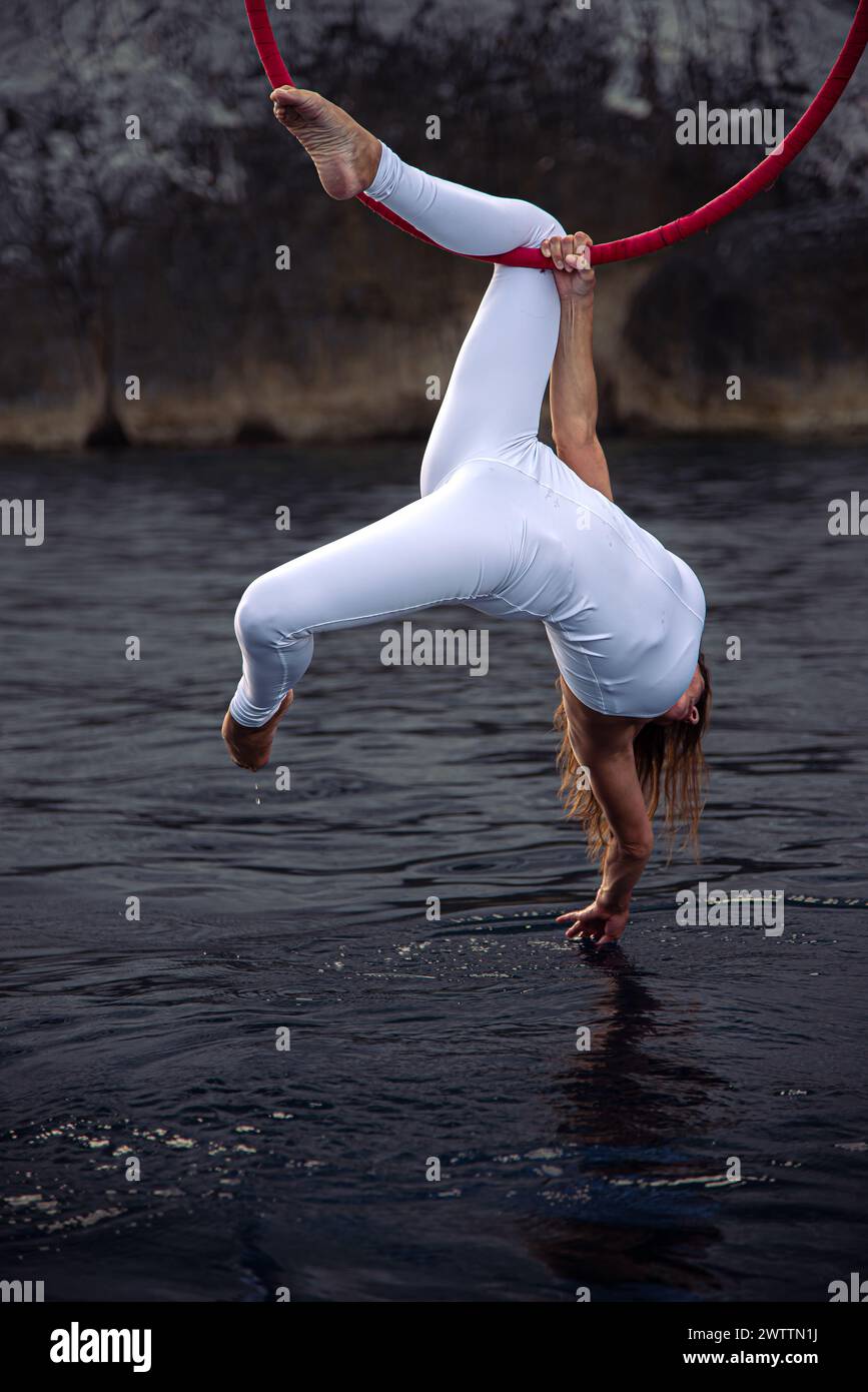 Female aerial acrobat performing with rope Stock Photo - Alamy