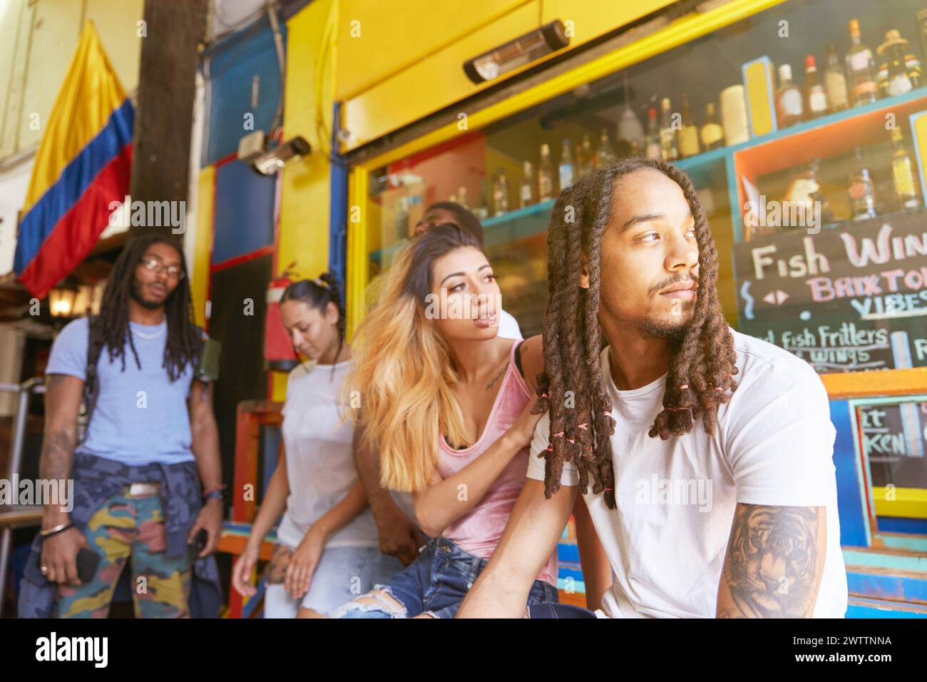 People waiting outside a colorful restaurant Stock Photo - Alamy
