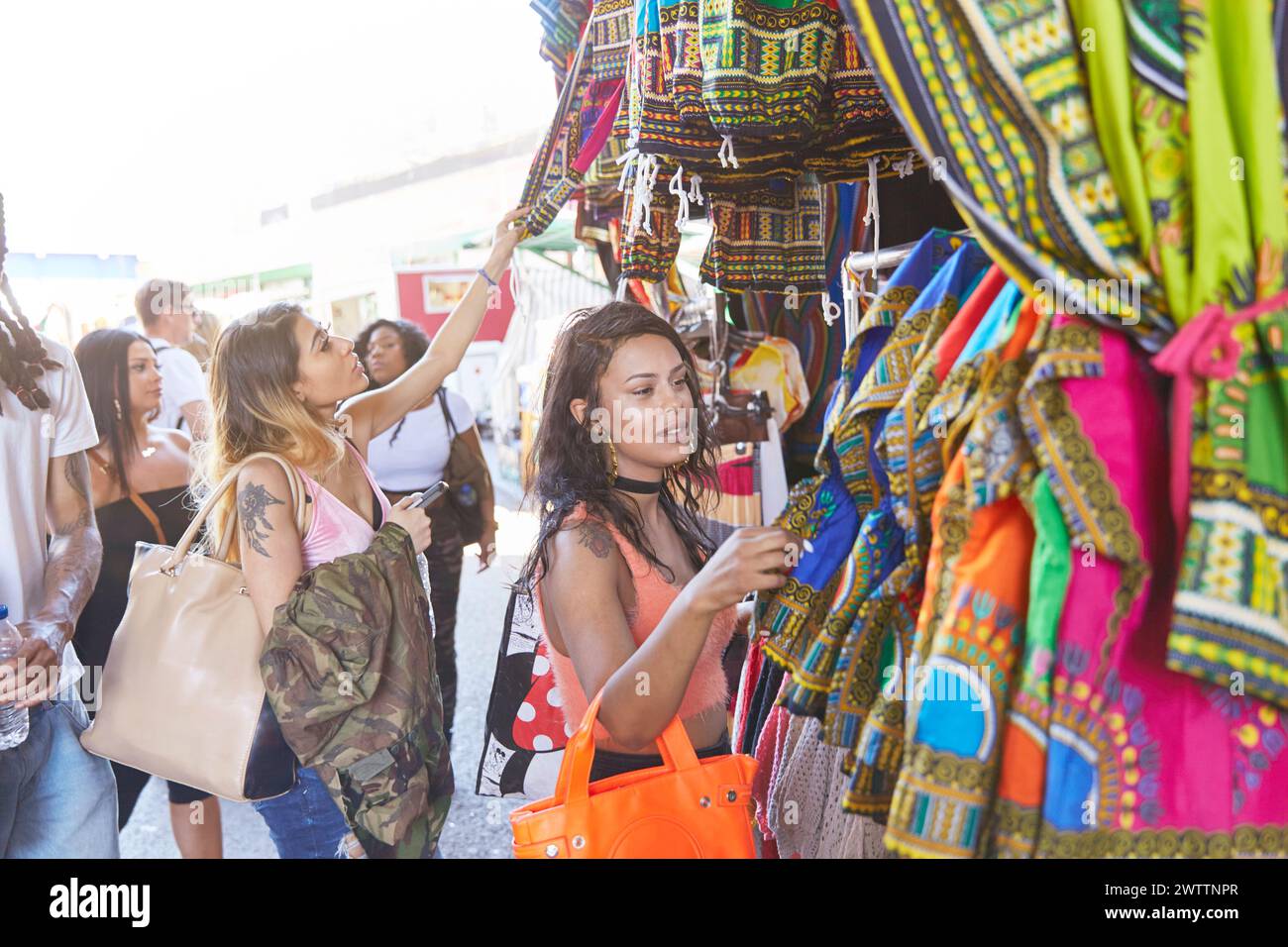 Woman shopping at a colorful clothing stall Stock Photo - Alamy