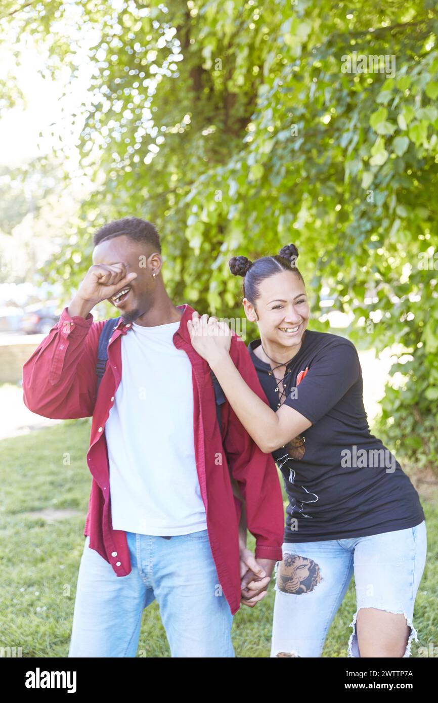 Two people laughing and playing outdoors Stock Photo - Alamy