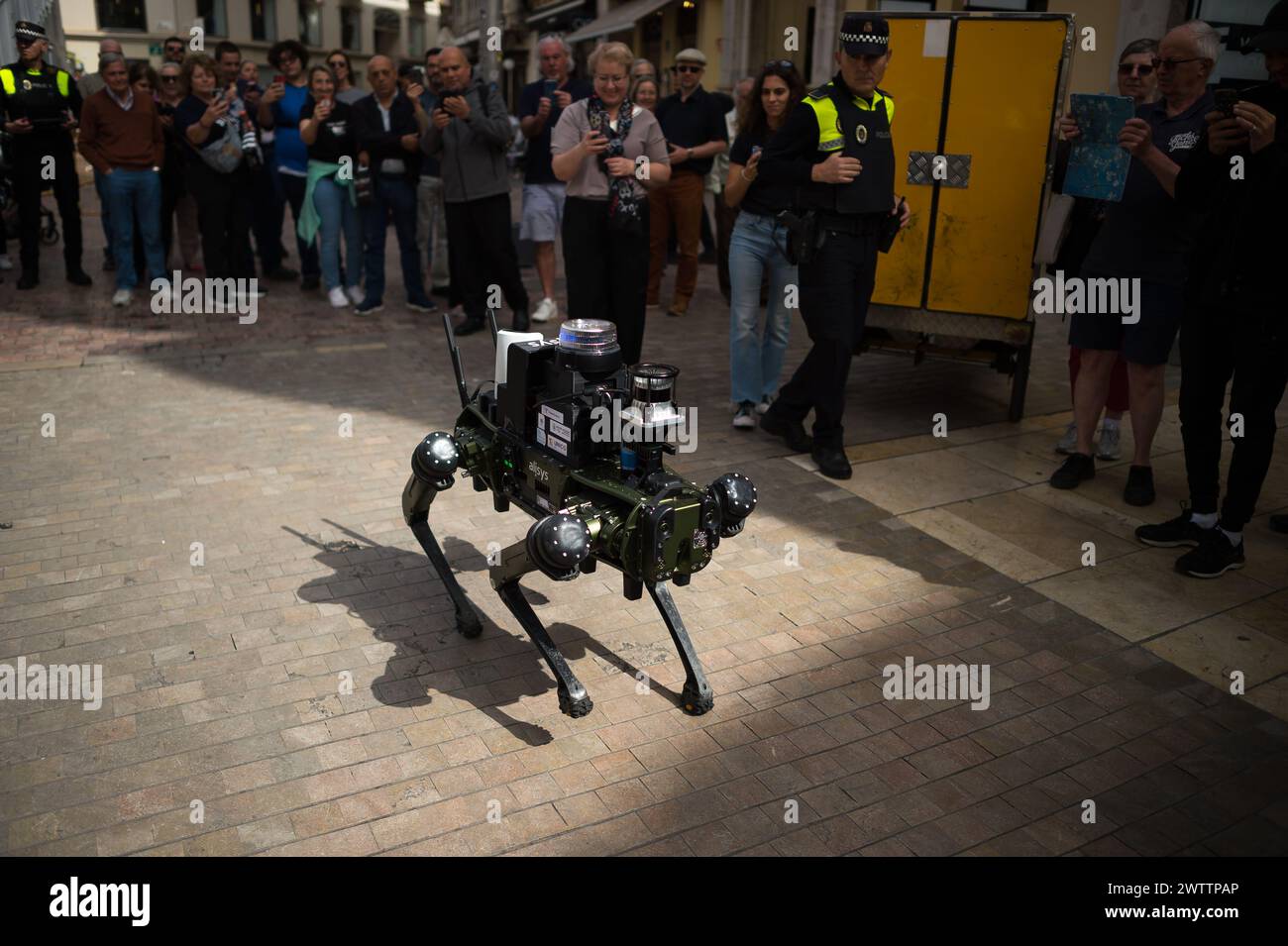 A robotic police dog prototype is seen patrolling Larios street as ...