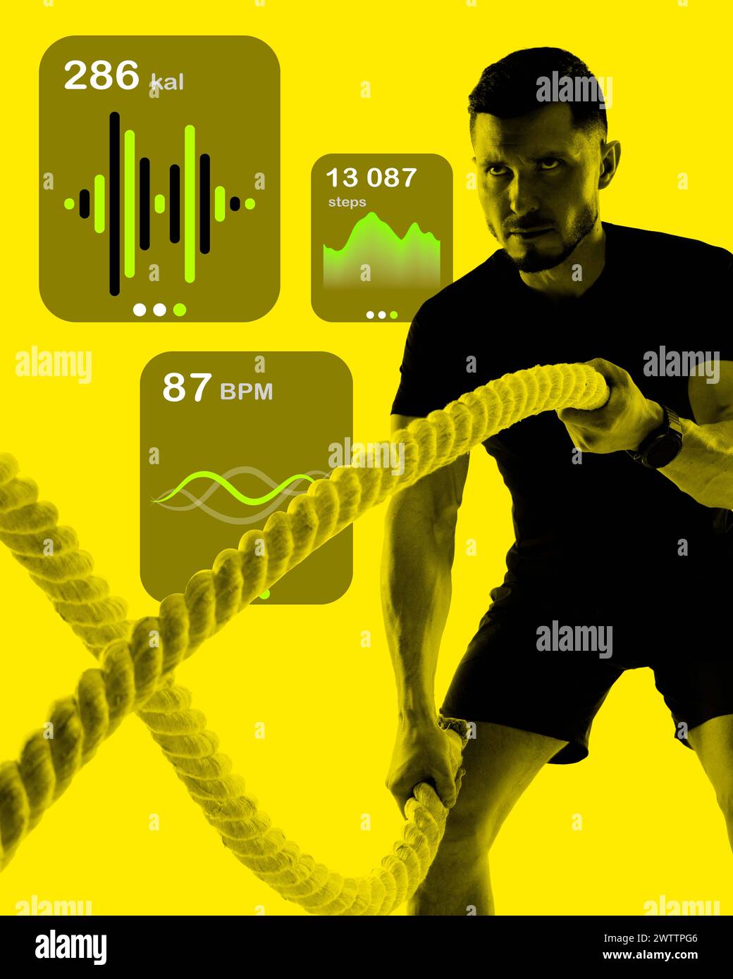 Concentrated muscular man training with rope against monochrome yellow ...