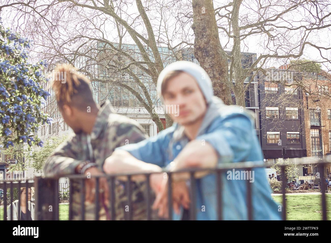 Two individuals leaning park railing hi-res stock photography and ...