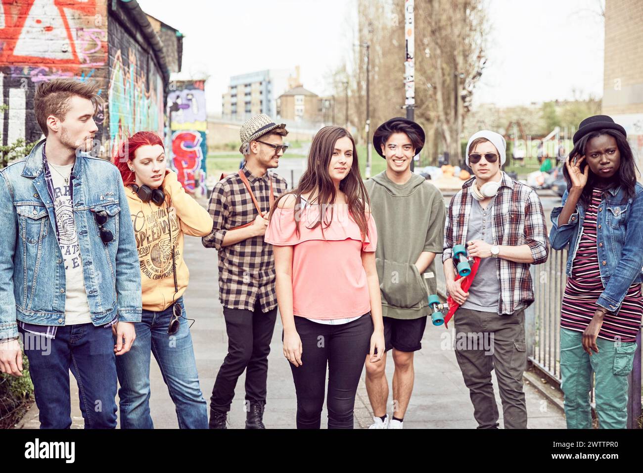 Group of young adults posing together in urban setting Stock Photo - Alamy