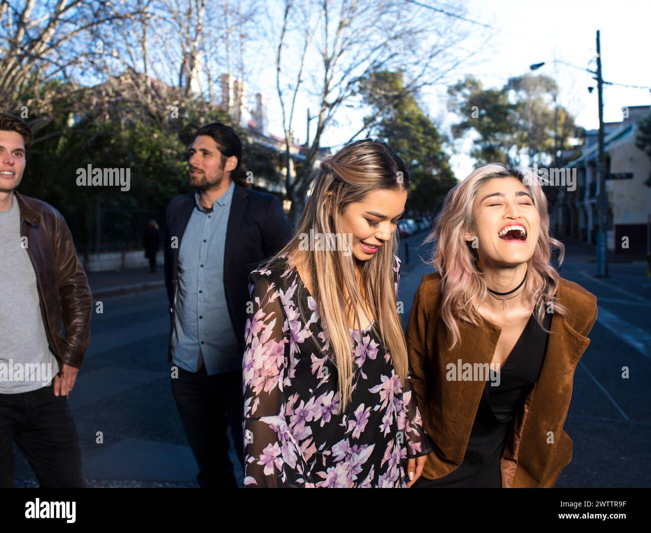 Group of friends walking and laughing together Stock Photo - Alamy