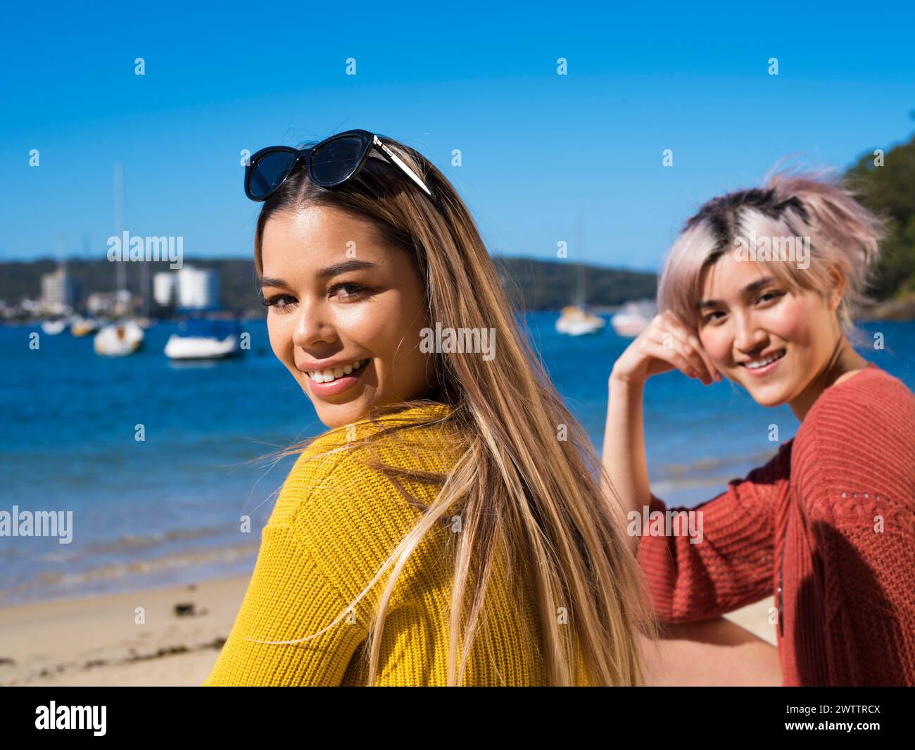 Two smiling friends at the beach Stock Photo - Alamy