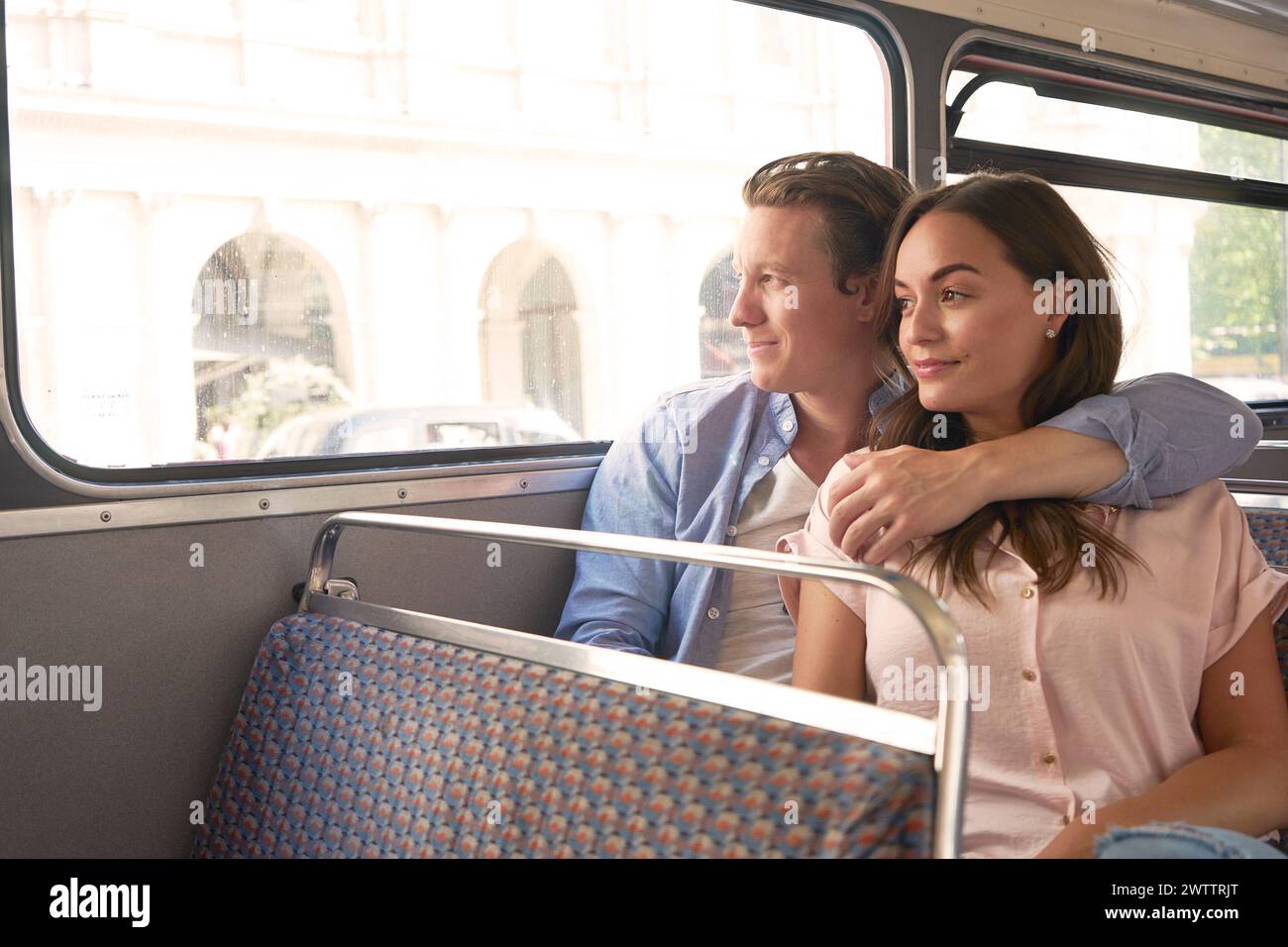 Couple sitting together on a bus Stock Photo - Alamy