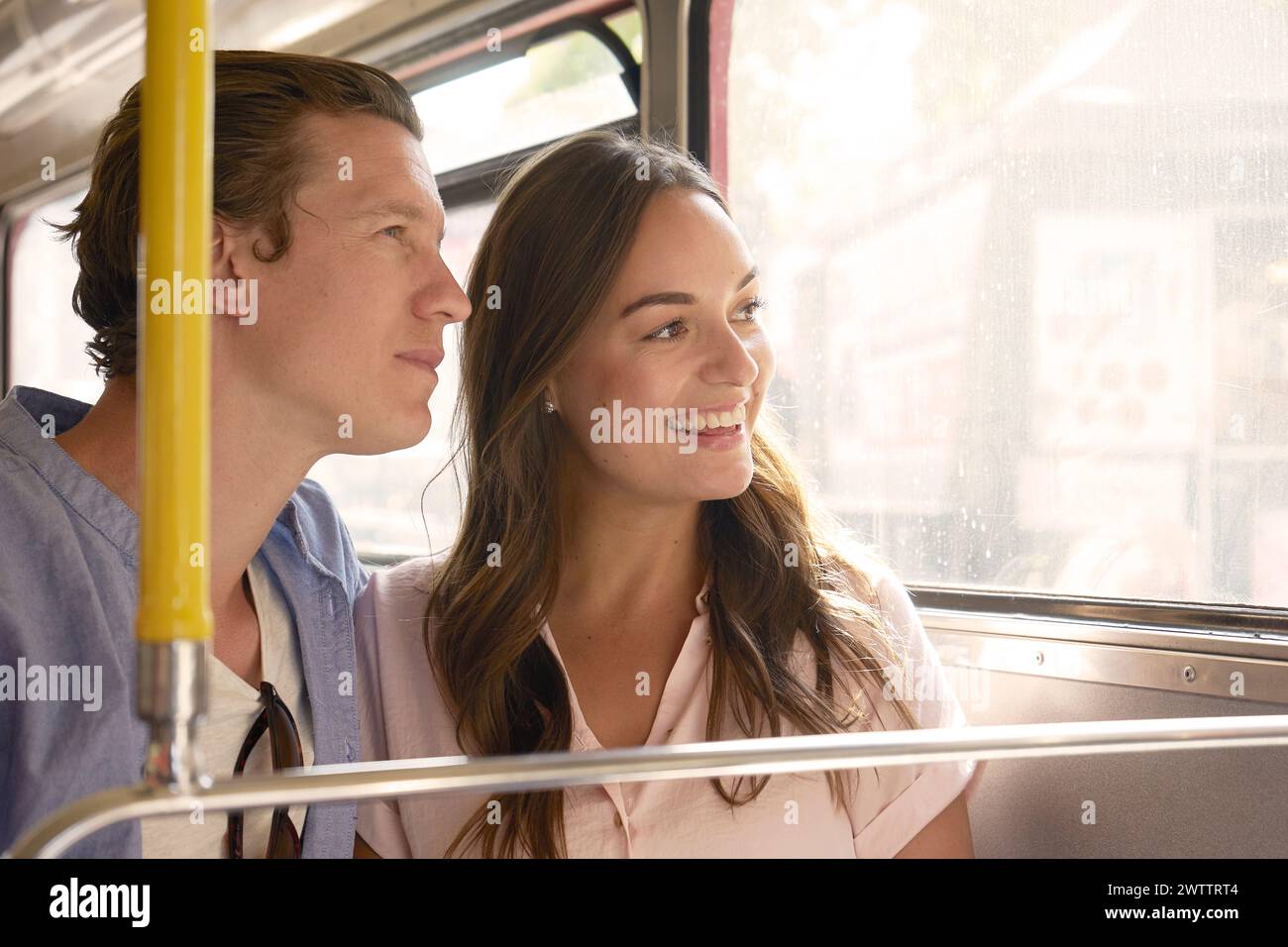 Couple smiling inside a bus Stock Photo - Alamy