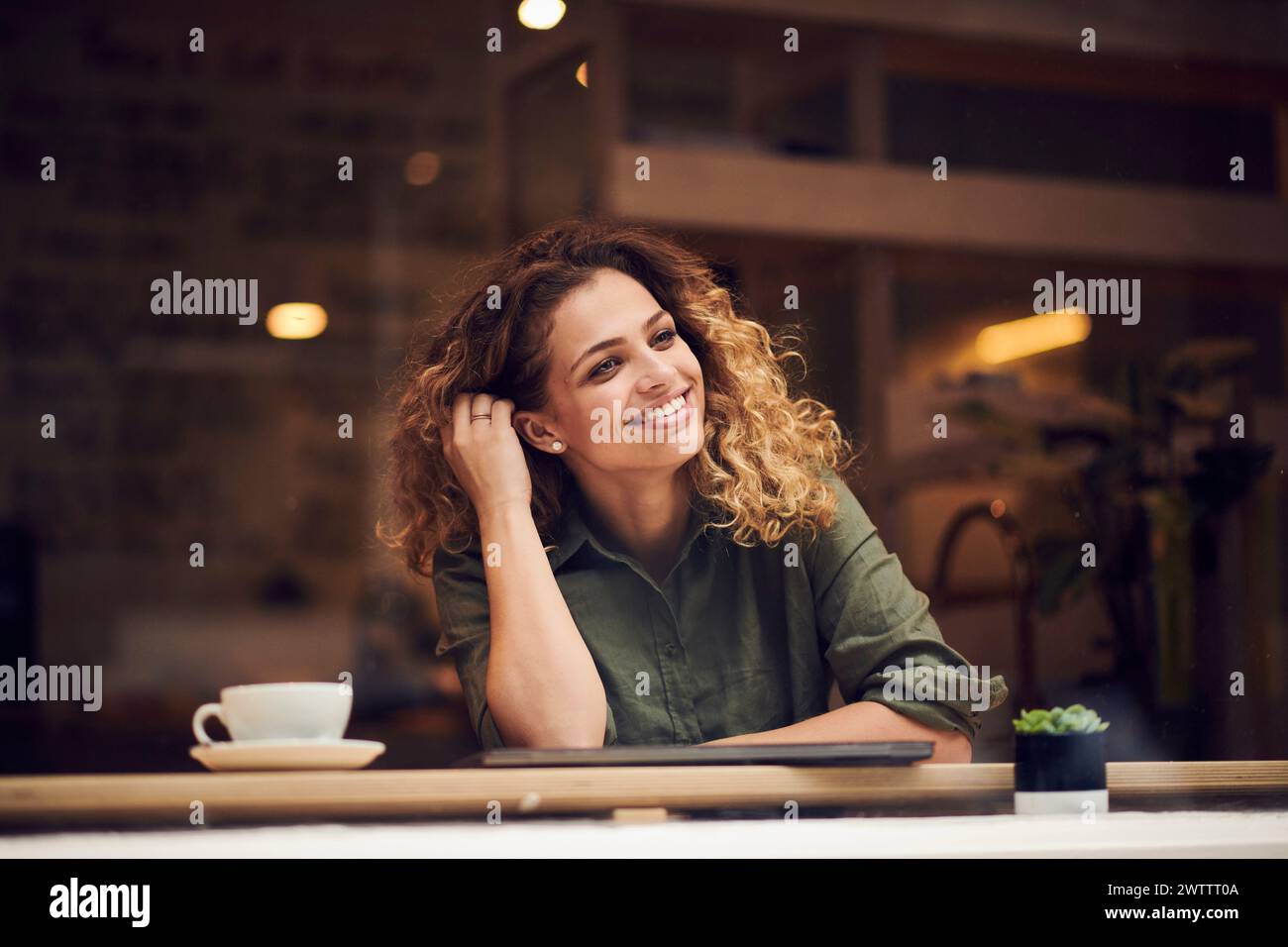 Woman smiling inside a cozy café Stock Photo - Alamy