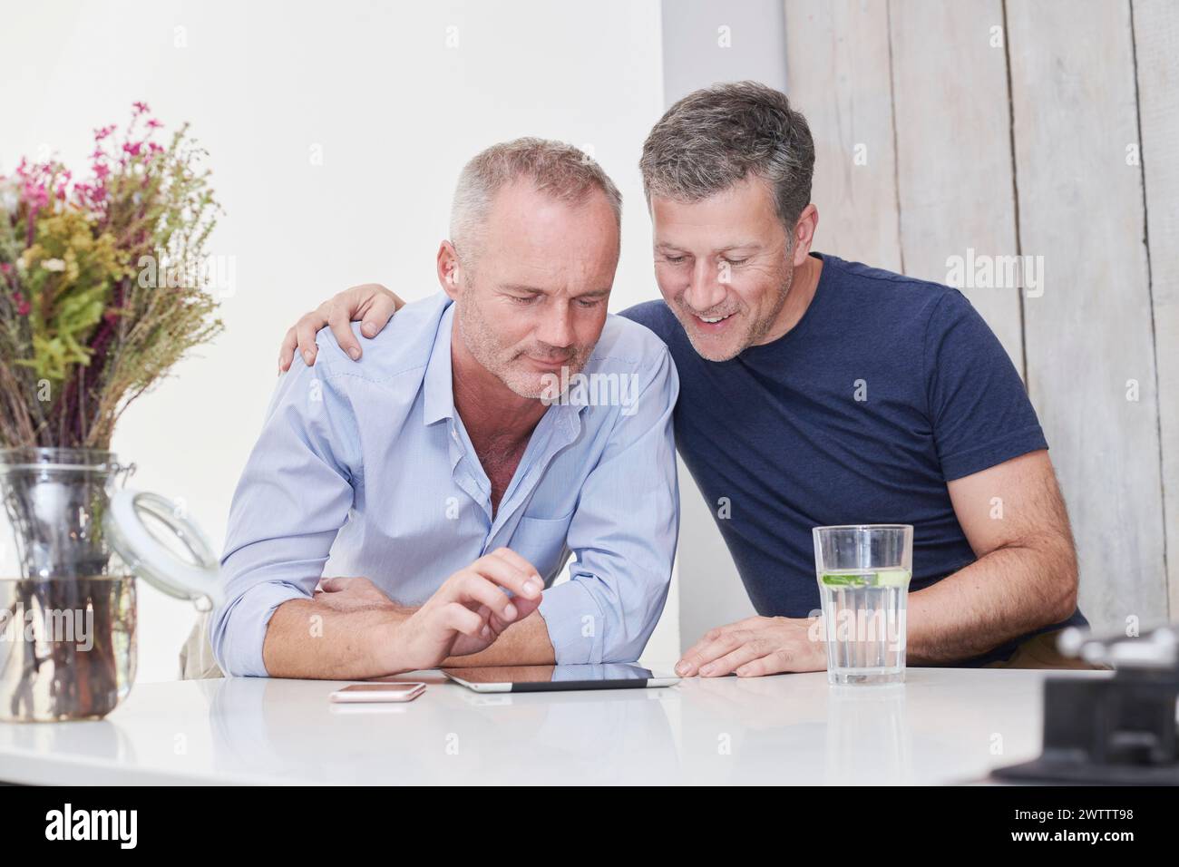 Two men at table hi-res stock photography and images - Alamy