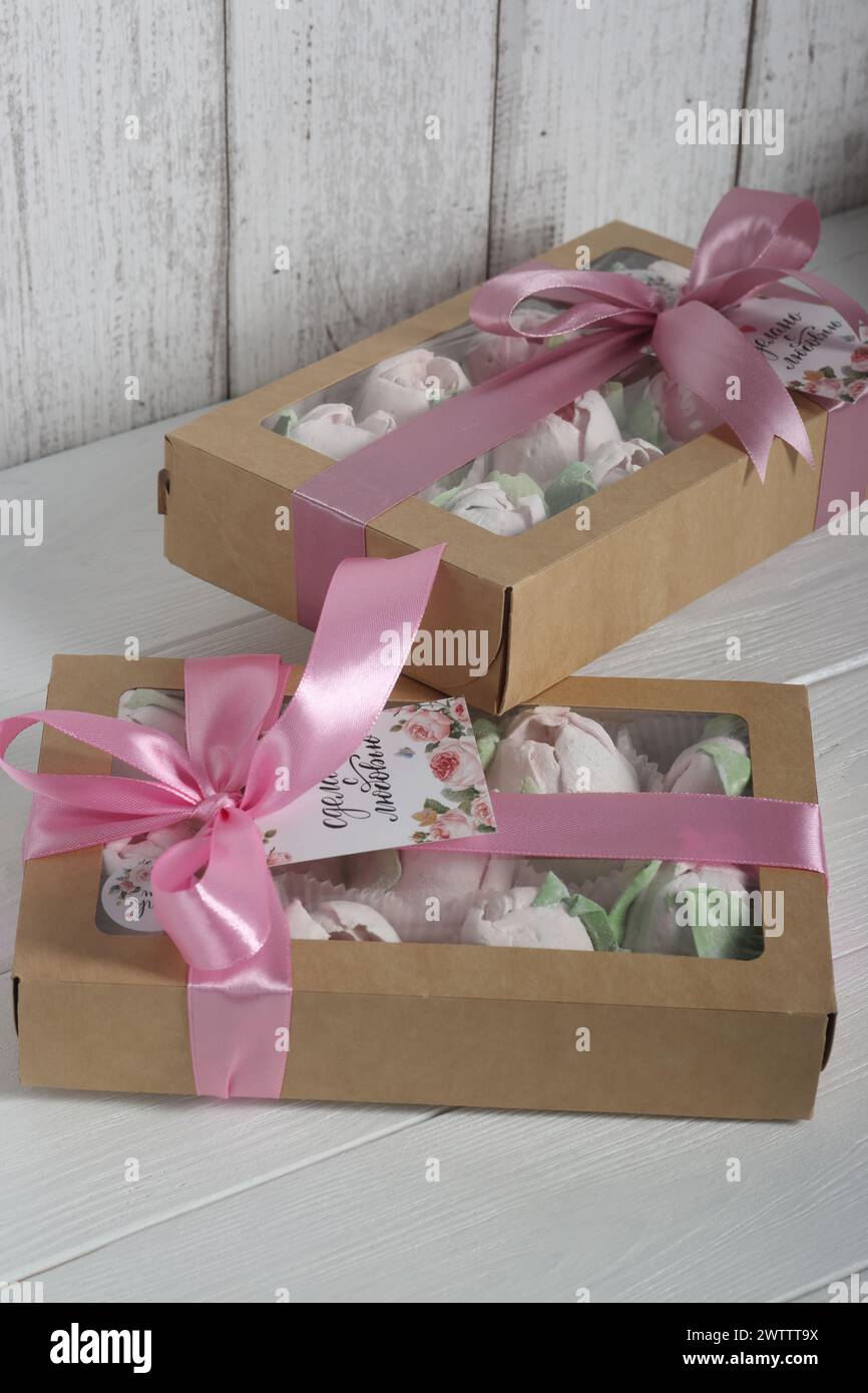 Marshmallows in boxes with a transparent lid. The box is tied with a ...