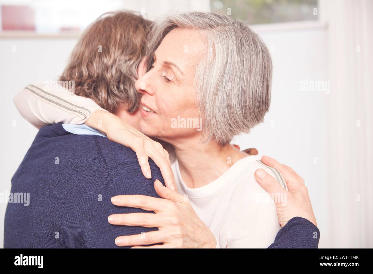 Woman embracing a loved one Stock Photo - Alamy