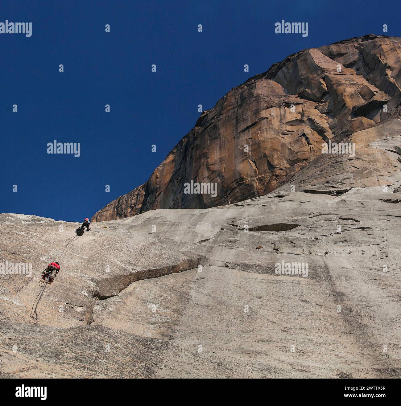 Rock climbers ascending a steep cliff Stock Photo - Alamy