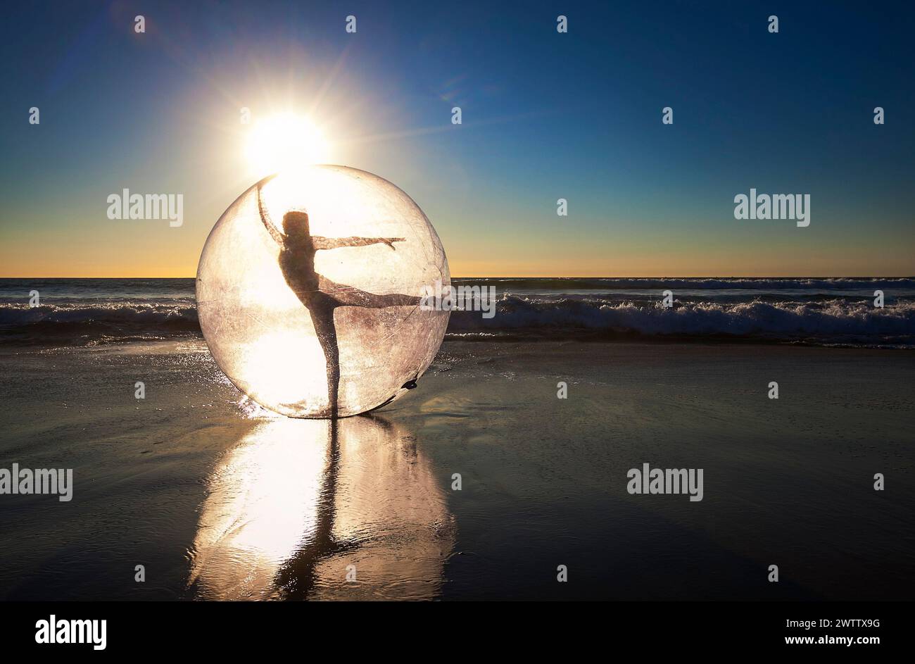 Dancer in a bubble at sunset on the beach Stock Photo - Alamy