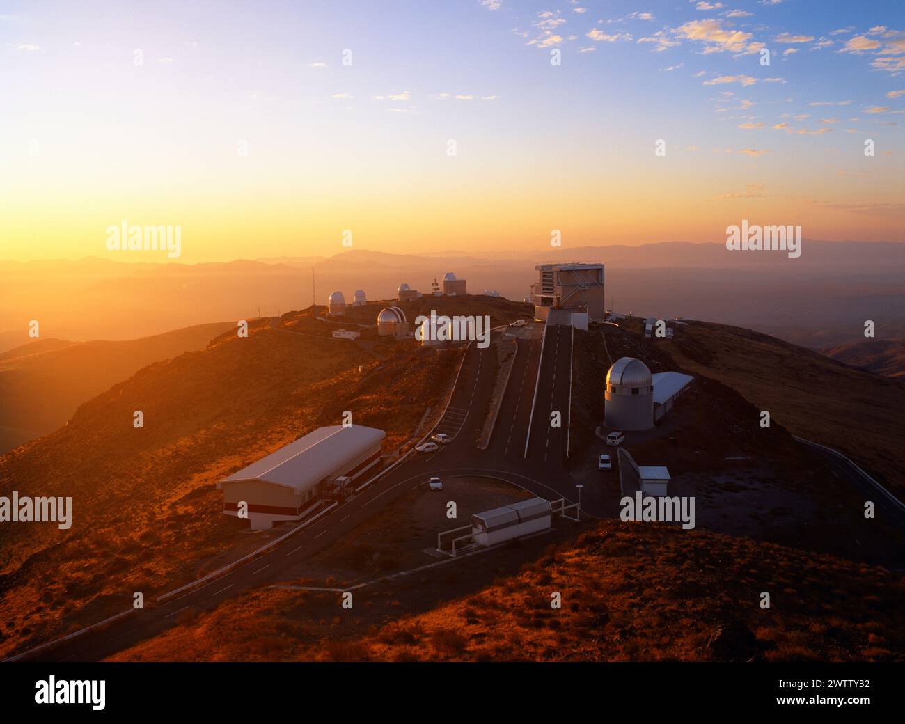 Sunset at an observatory with multiple telescopes Stock Photo - Alamy