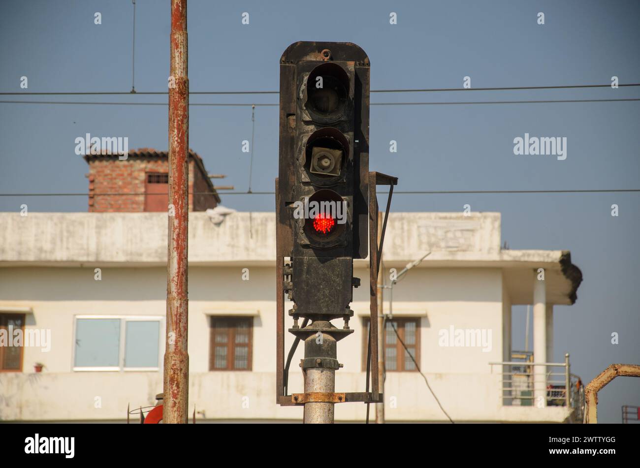 Railway Red signal while train is passing Stock Photo - Alamy