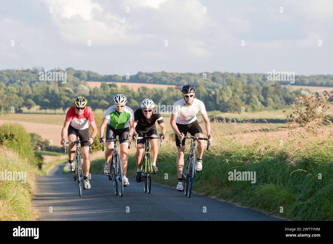 Cyclists riding on country road hi-res stock photography and images - Alamy