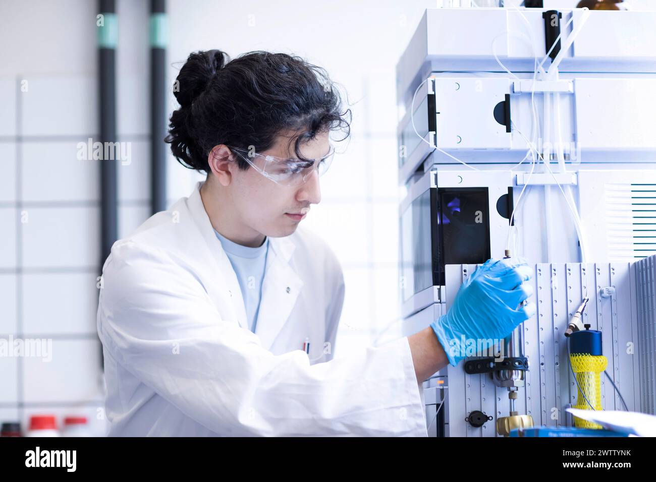 A focused scientist operating laboratory equipment Stock Photo - Alamy