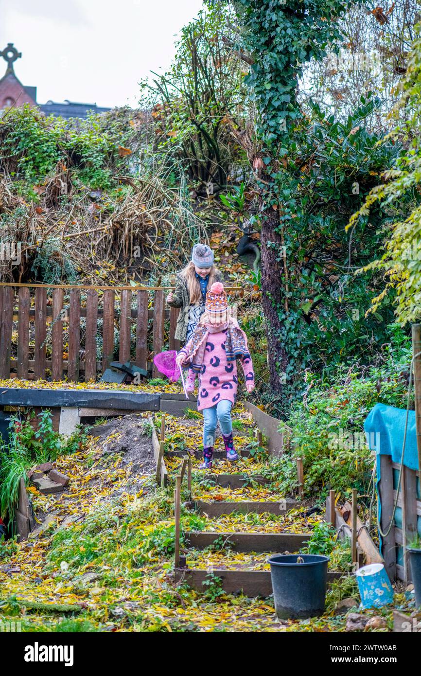 Adult and child descending outdoor stairs surrounded by greenery Stock ...