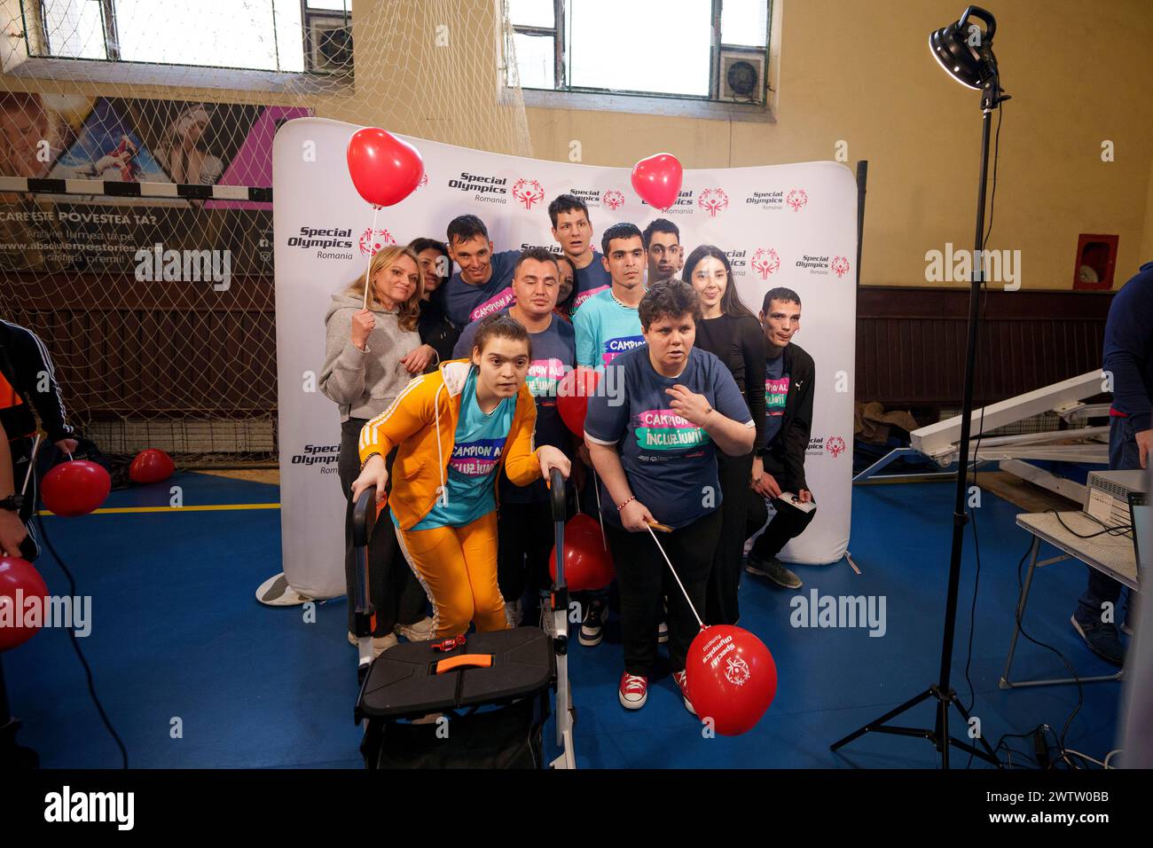 People pose with heart shaped balloons at the end of a sports ...