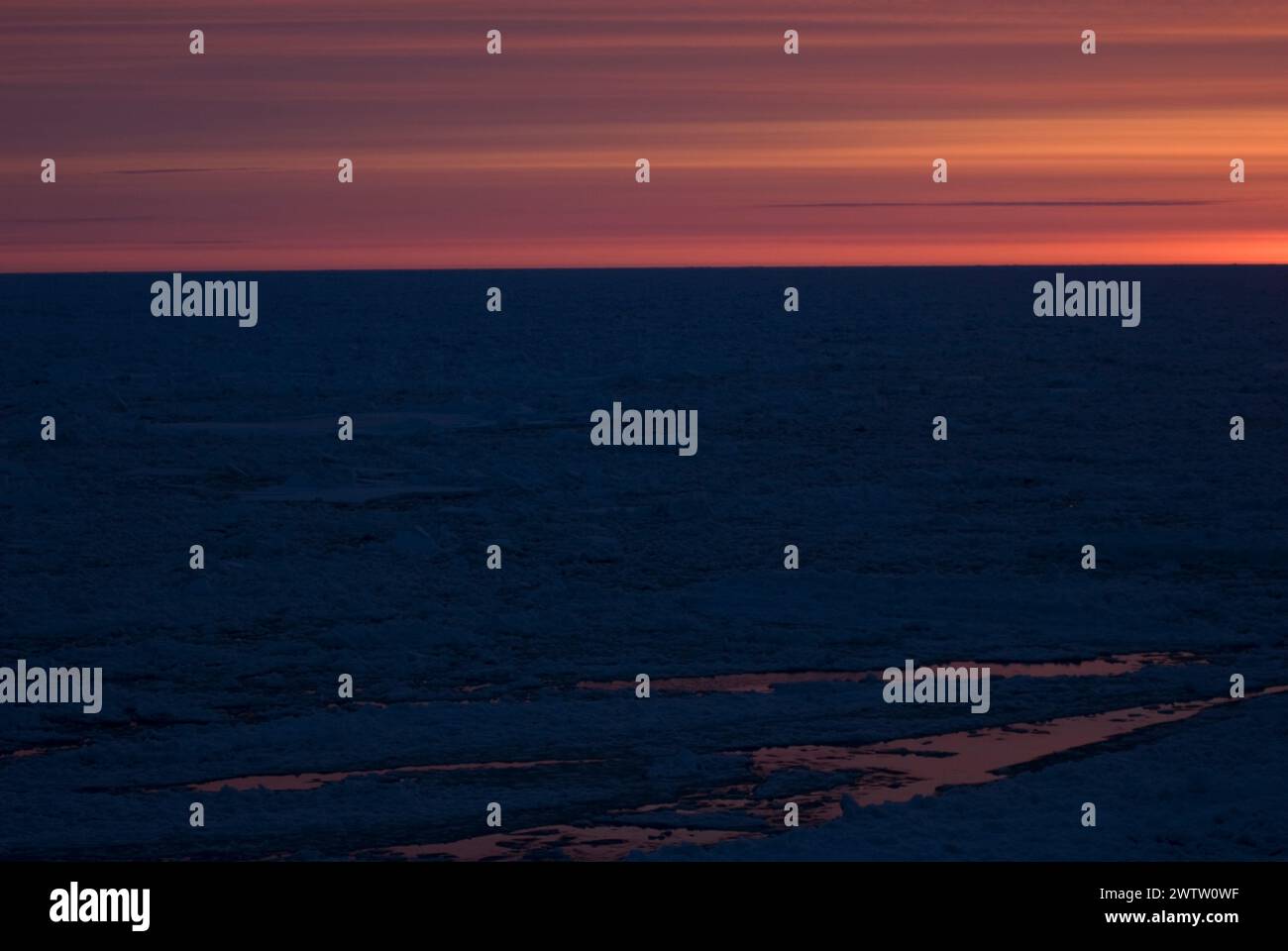 Seascape of sunset over open lead rough pack ice over the Chukchi sea ...
