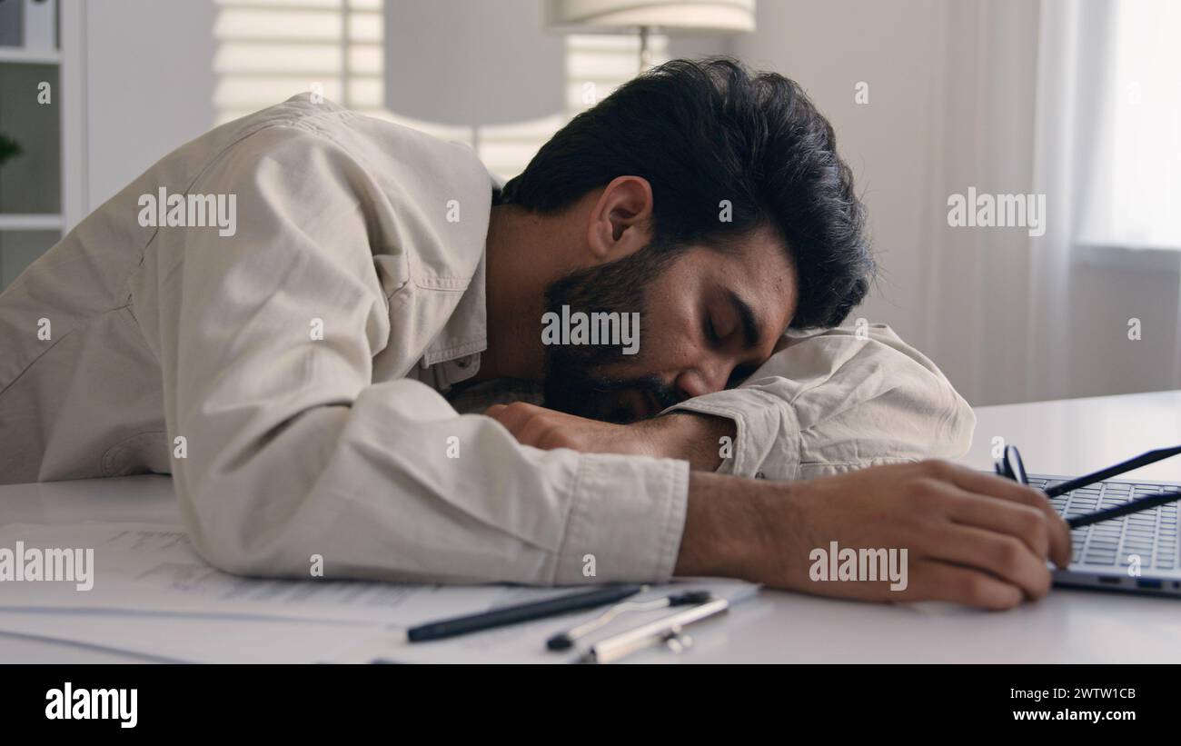 Lazy weary sleepy male manager tired exhausted Arabian Indian ...