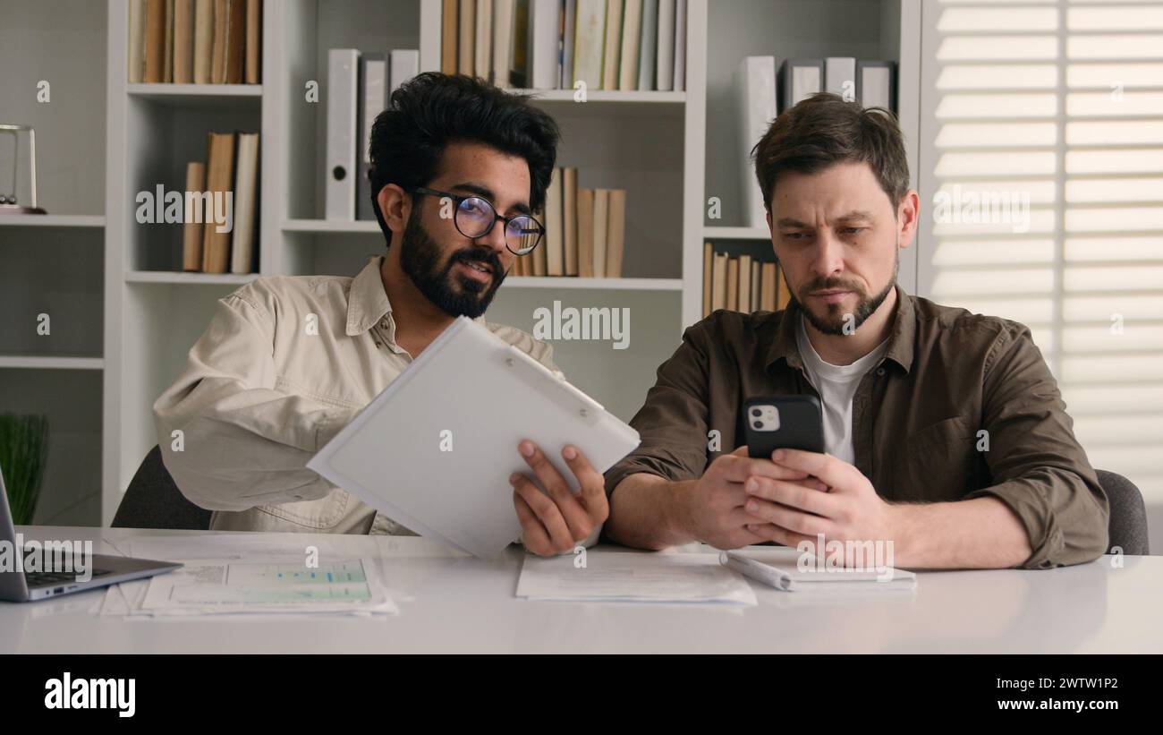 Two businessmen multiracial men co-workers in office Arabian Indian ...