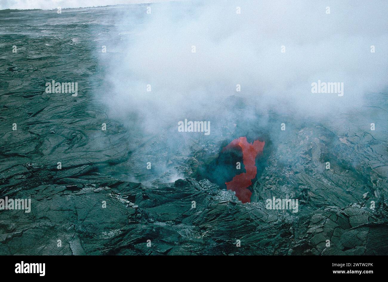 Window in crust showing red molten flowing lava from helicopter, taken ...