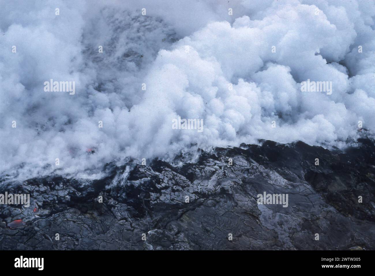 Steam from lava flowing into sea from helicopter, taken in 1992, Hawai ...