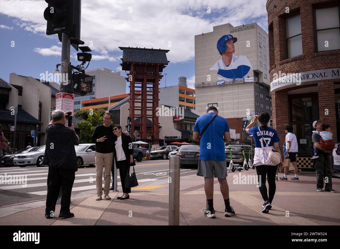 People take pictures with a mural in progress of Los Angeles Dodgers ...