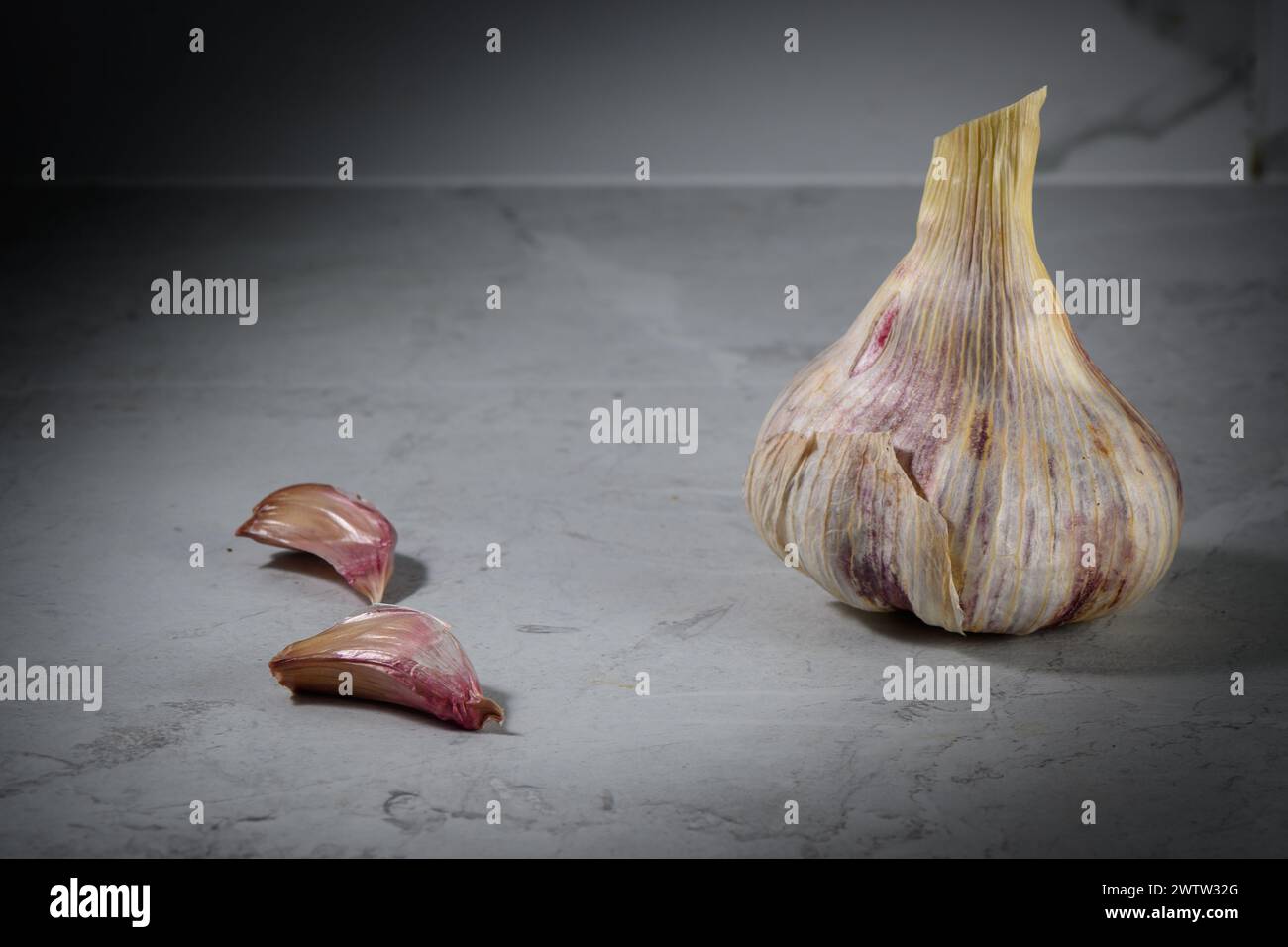 Still life photo of organic whole garlic on a light stone background 3 ...