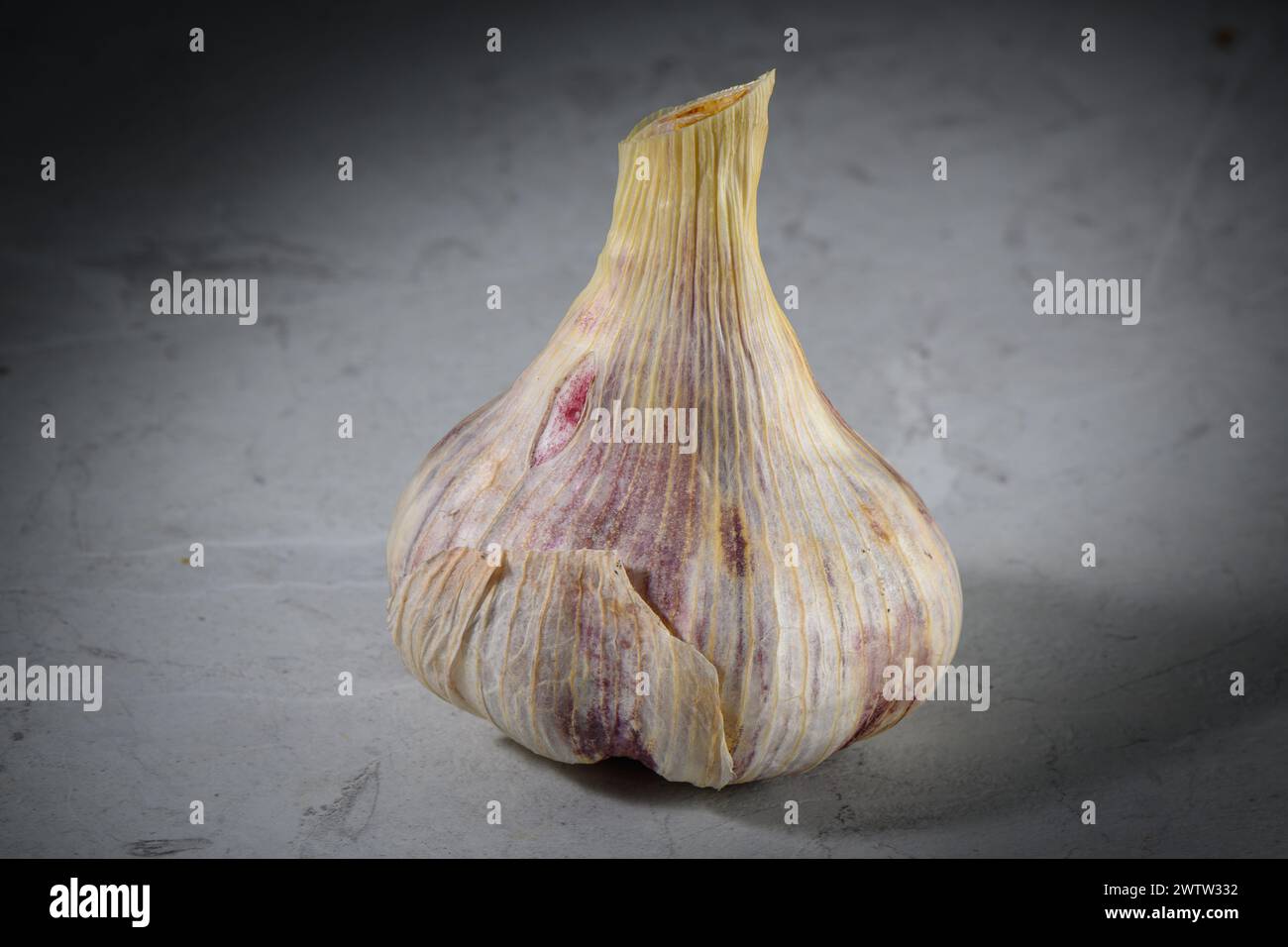 Still life photo of organic whole garlic on a light stone background 4 ...