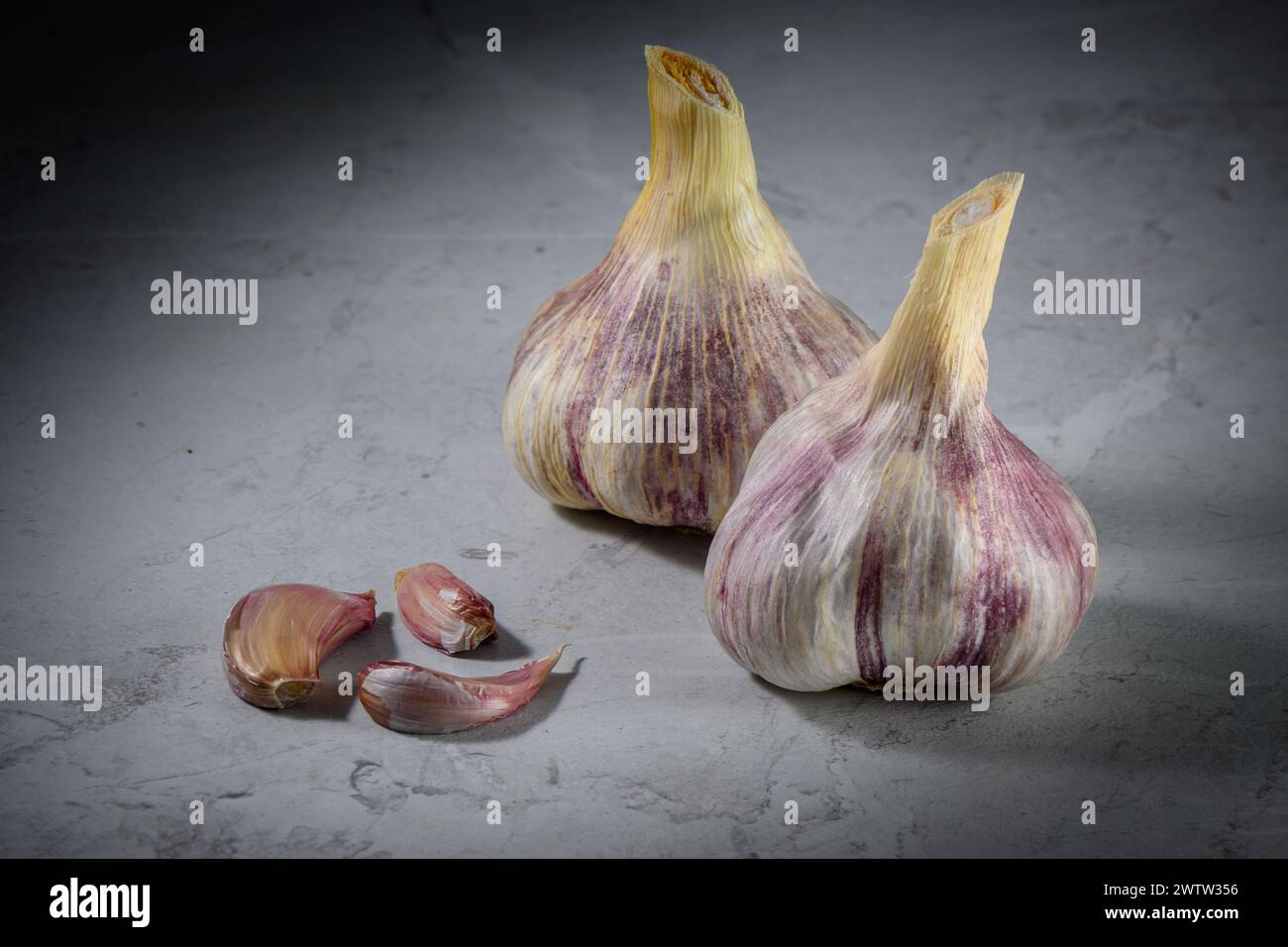 Still life photo of organic whole garlic on a light stone background ...
