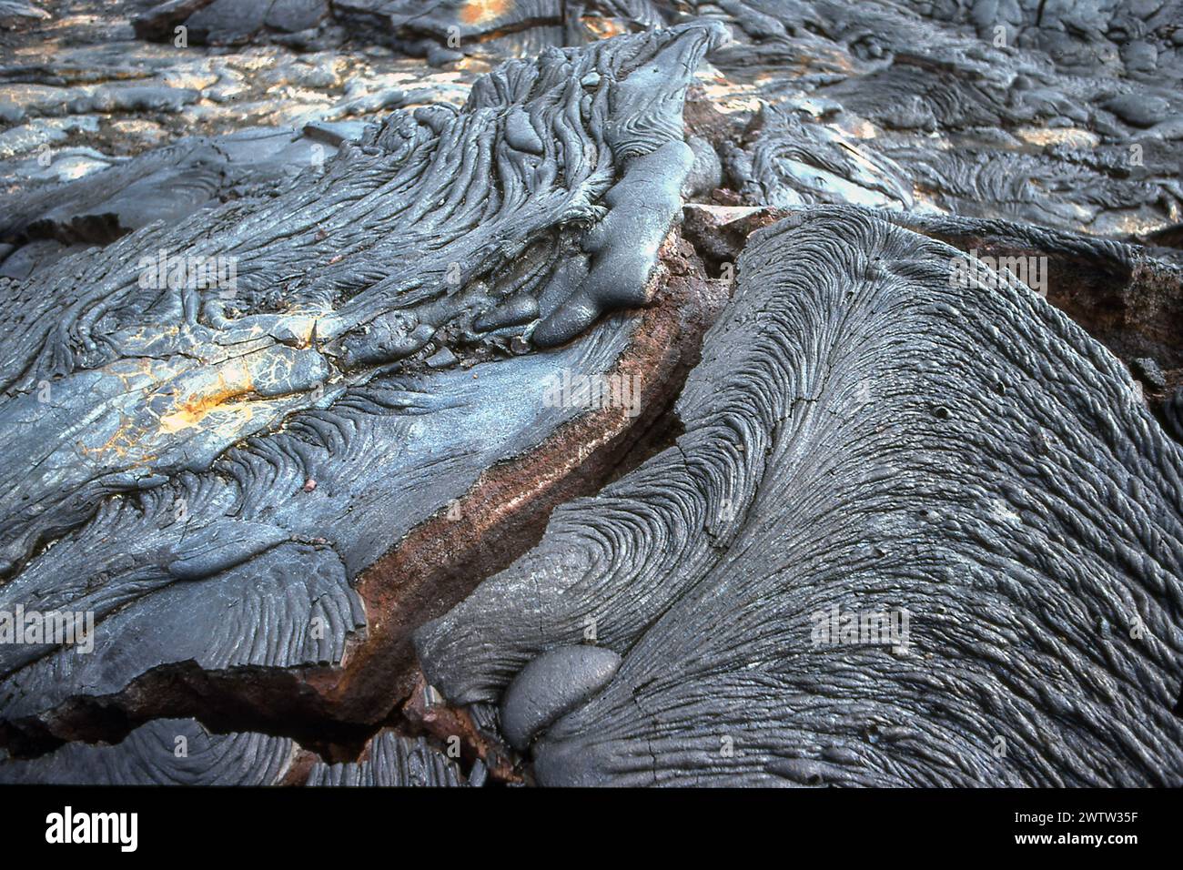 Cooled lava with cracks, folds, and mineral precipitation, taken in ...