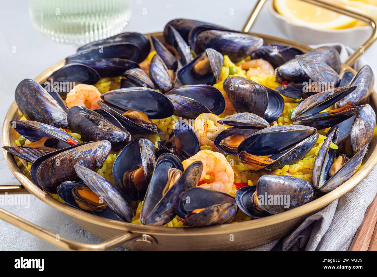 Seafood paella with mussels and shrimps in traditional plate, served ...