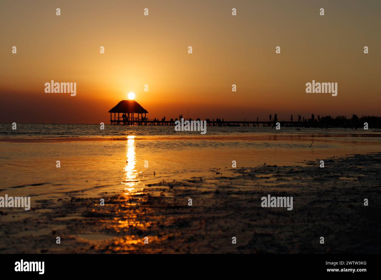 Sunset silhouette view of pier or hut in holbox quintana roo mexico ...
