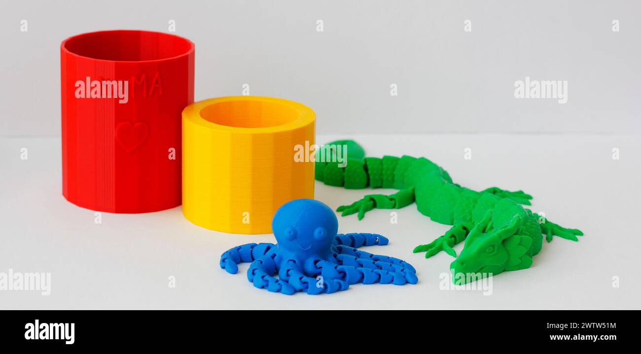 Collection of four bright colorful plastic products created by a child ...