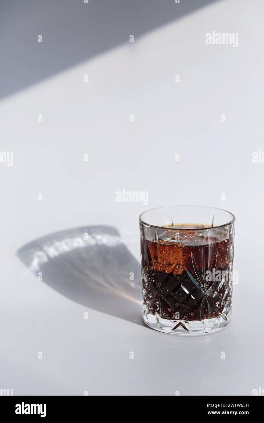 Whiskey cola cocktail with strong alcohol and ice in highball glass ...