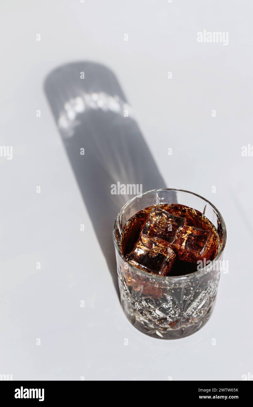 Whiskey cola cocktail with strong alcohol and ice in highball glass ...