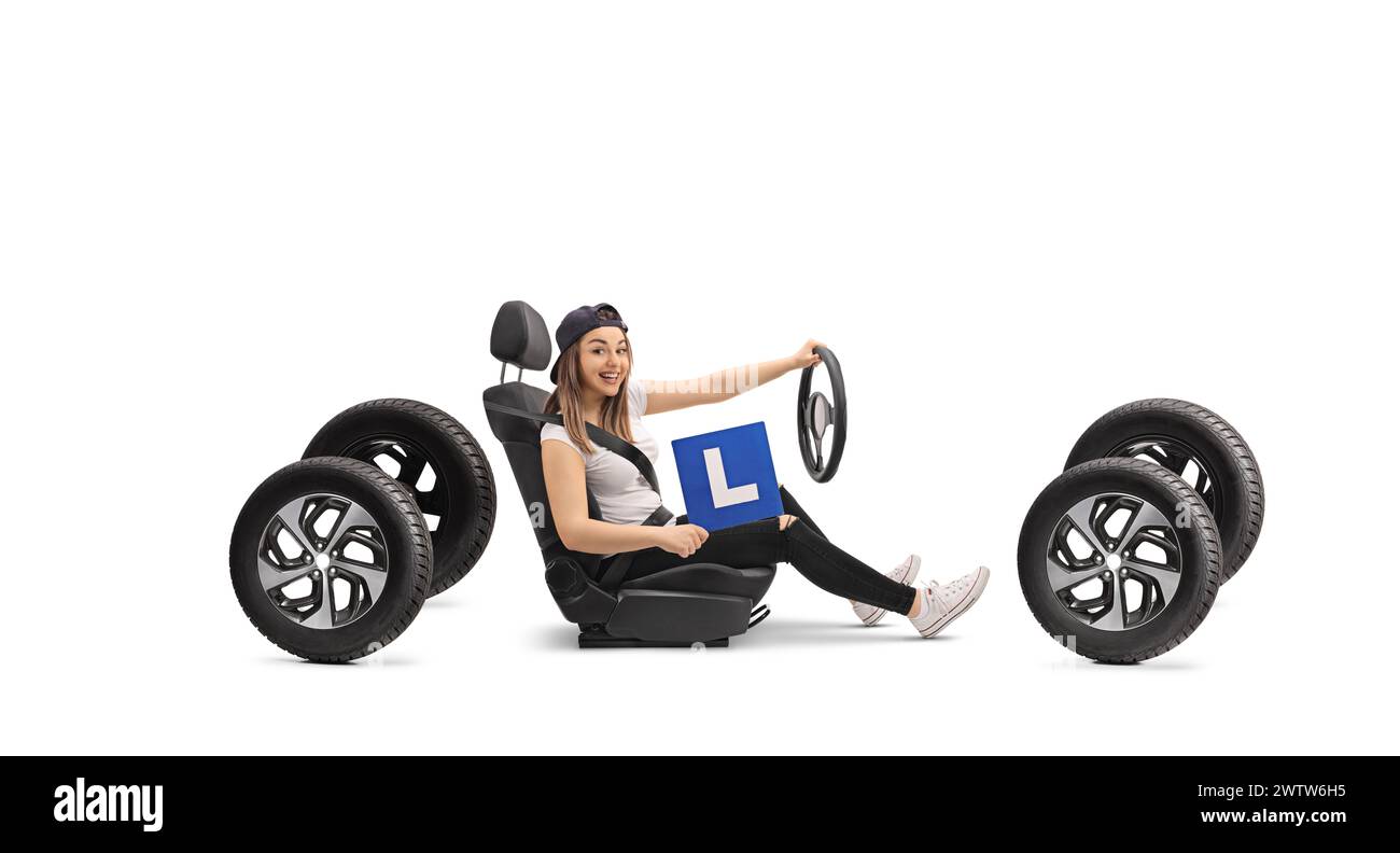 Happy girl holding an L-sign in a car seat isolated on white background ...