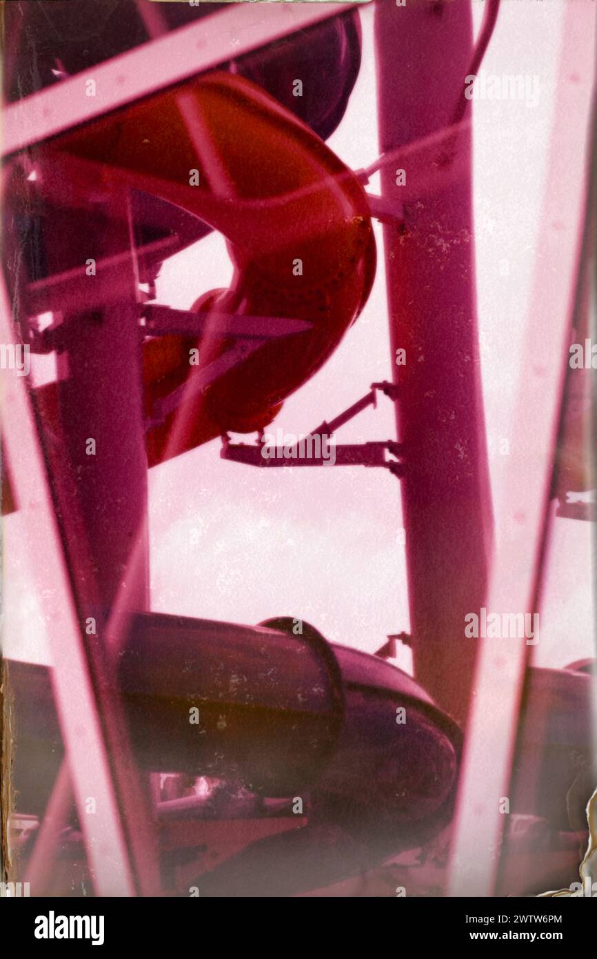 A close perspective of a red industrial slide with a weathered texture ...