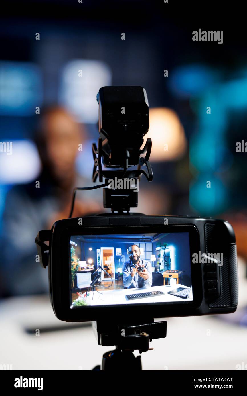 Focus on professional camera capturing footage of media star in blurry ...
