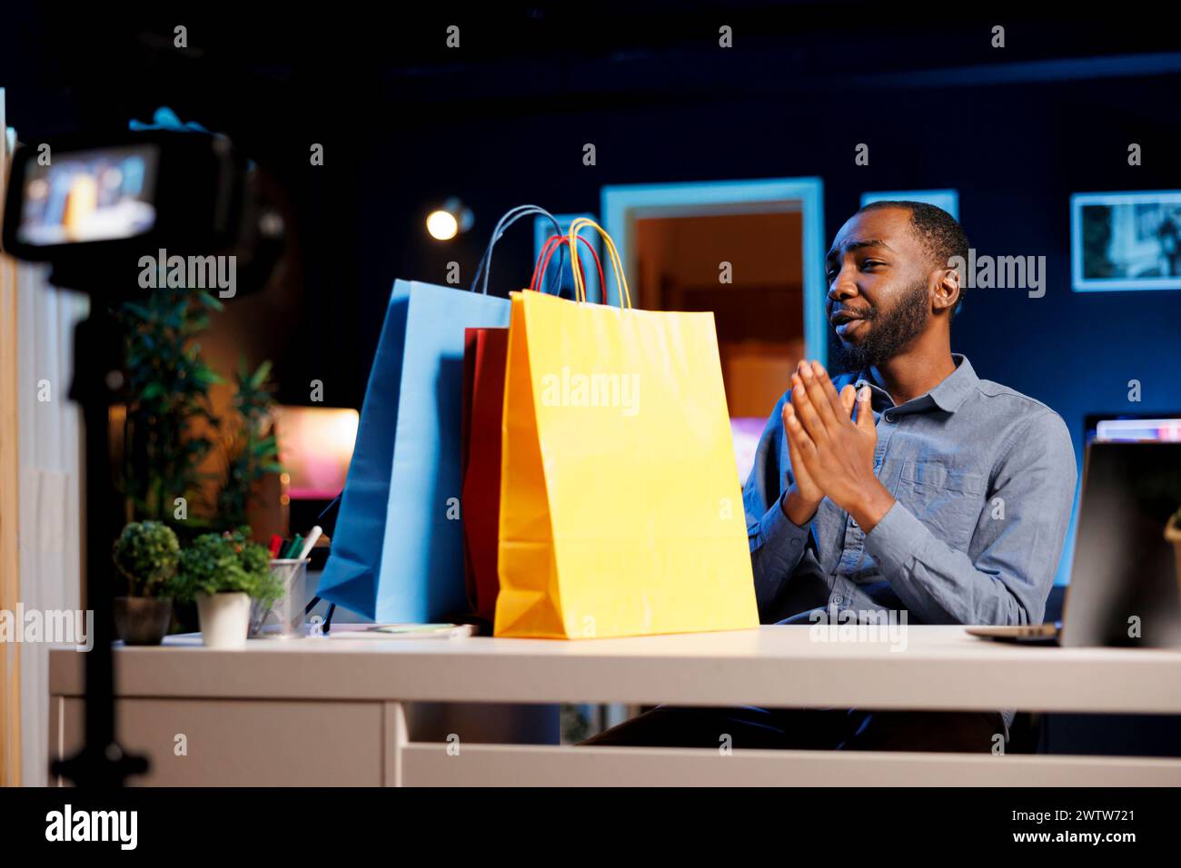 Influencer holding colorful shopping bags in hand, showing subscribers ...