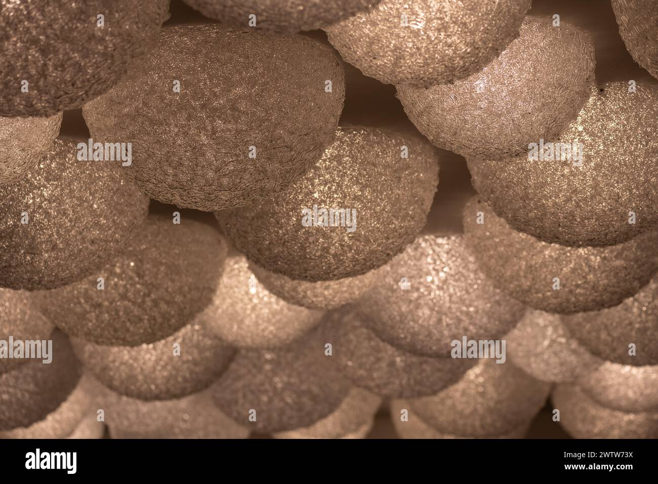 Close-up of stacked brown textured spheres creating a pattern ...