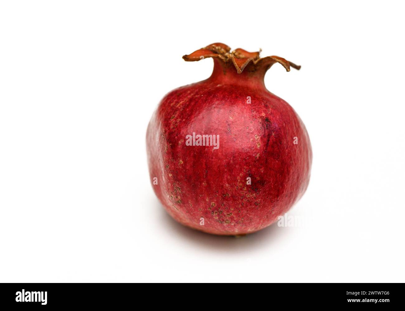 overripe pomegranate isolated on white background Stock Photo - Alamy